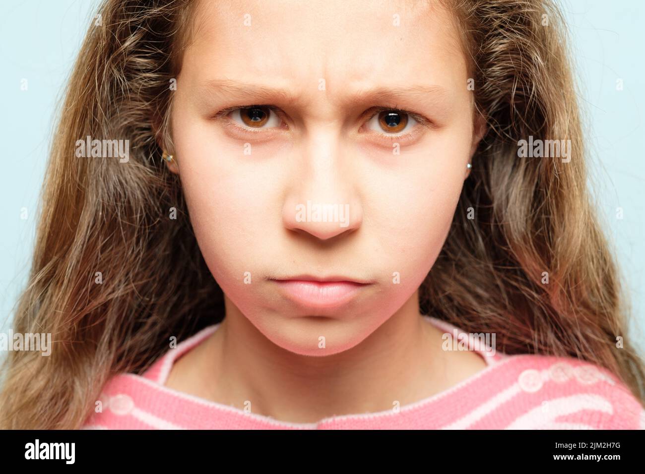 emotion face grumpy pursed lips frowning child Stock Photo - Alamy
