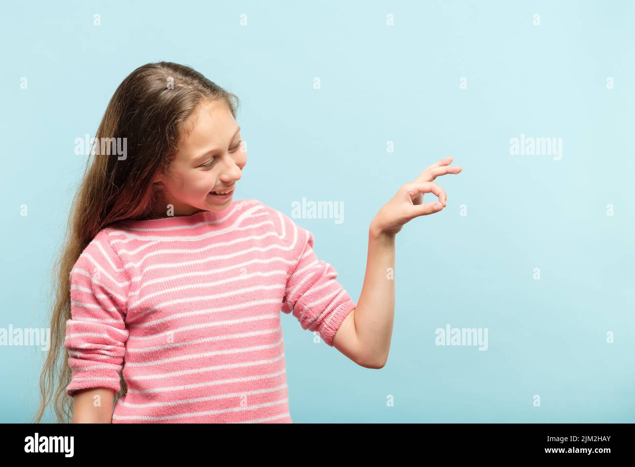 smiling girl holding virtual object string hands Stock Photo - Alamy
