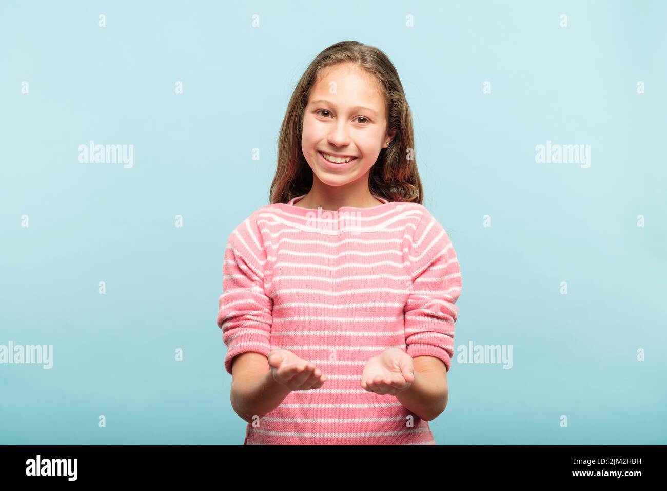 smiling girl holding virtual object empty hands Stock Photo - Alamy