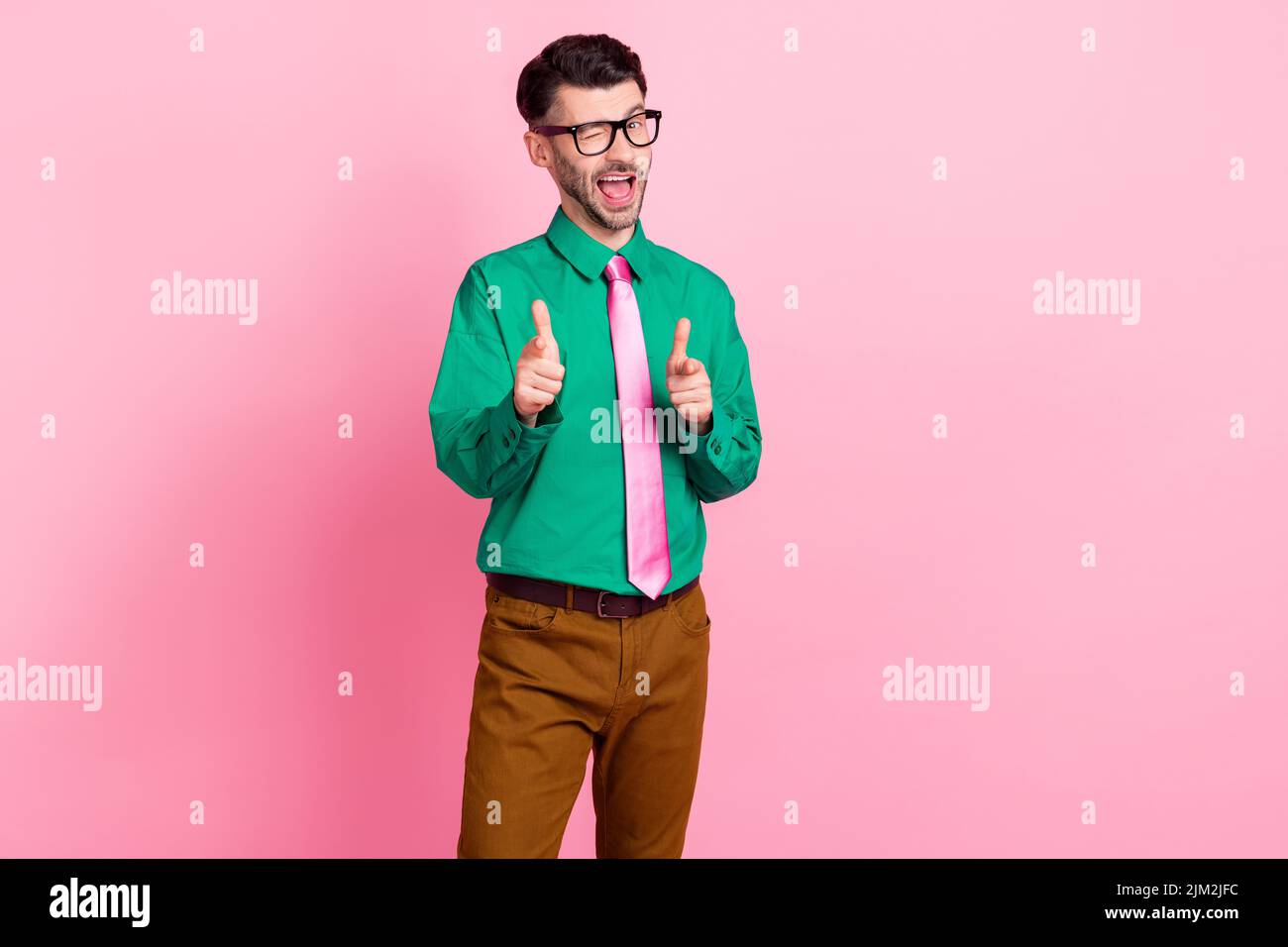 Portrait of young successful guy blinking pointing fingers you well ...