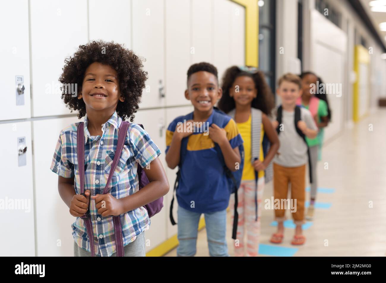 Portrait of multiracial smiling elementary school children with ...