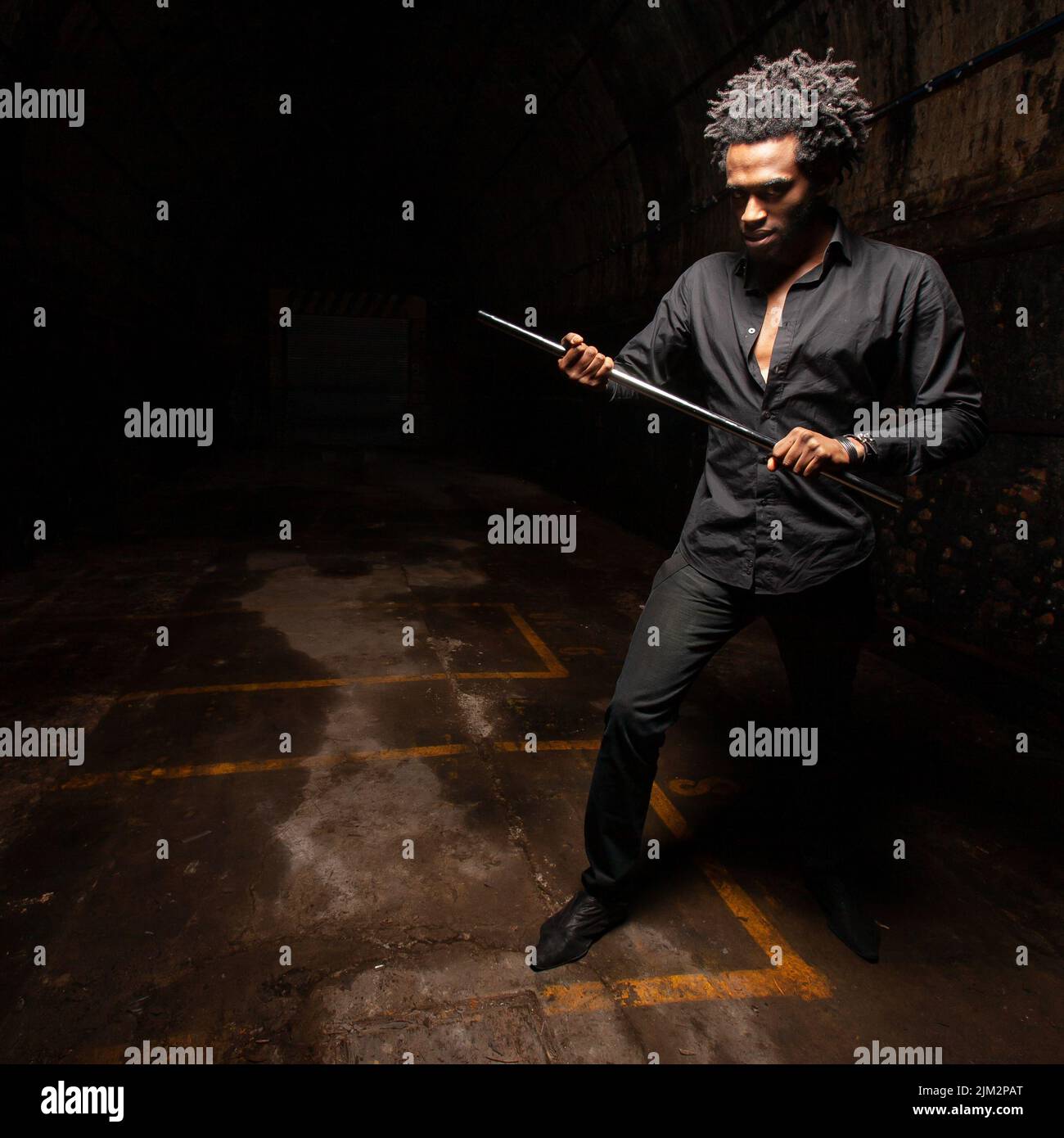 Dark Threat. A menacing character emerging from the shadows wielding a ...