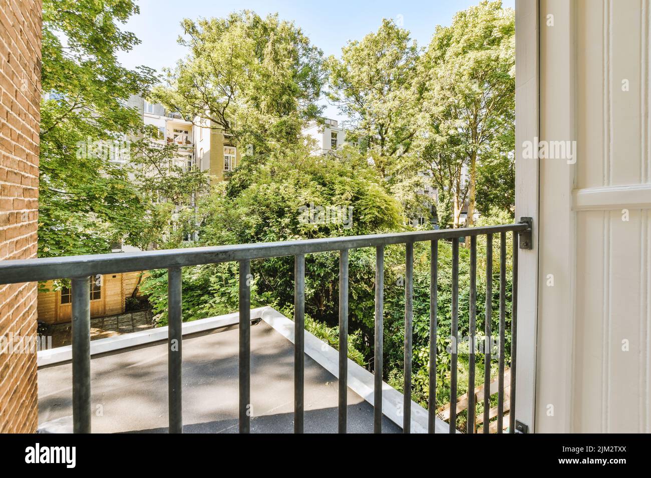 Narrow brick balcony with metal railings and door Stock Photo - Alamy