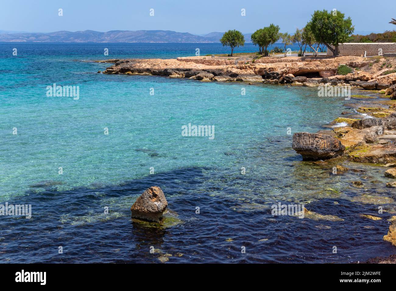 The coast of Aegina island with clear and blue waters of Mediterranean ...