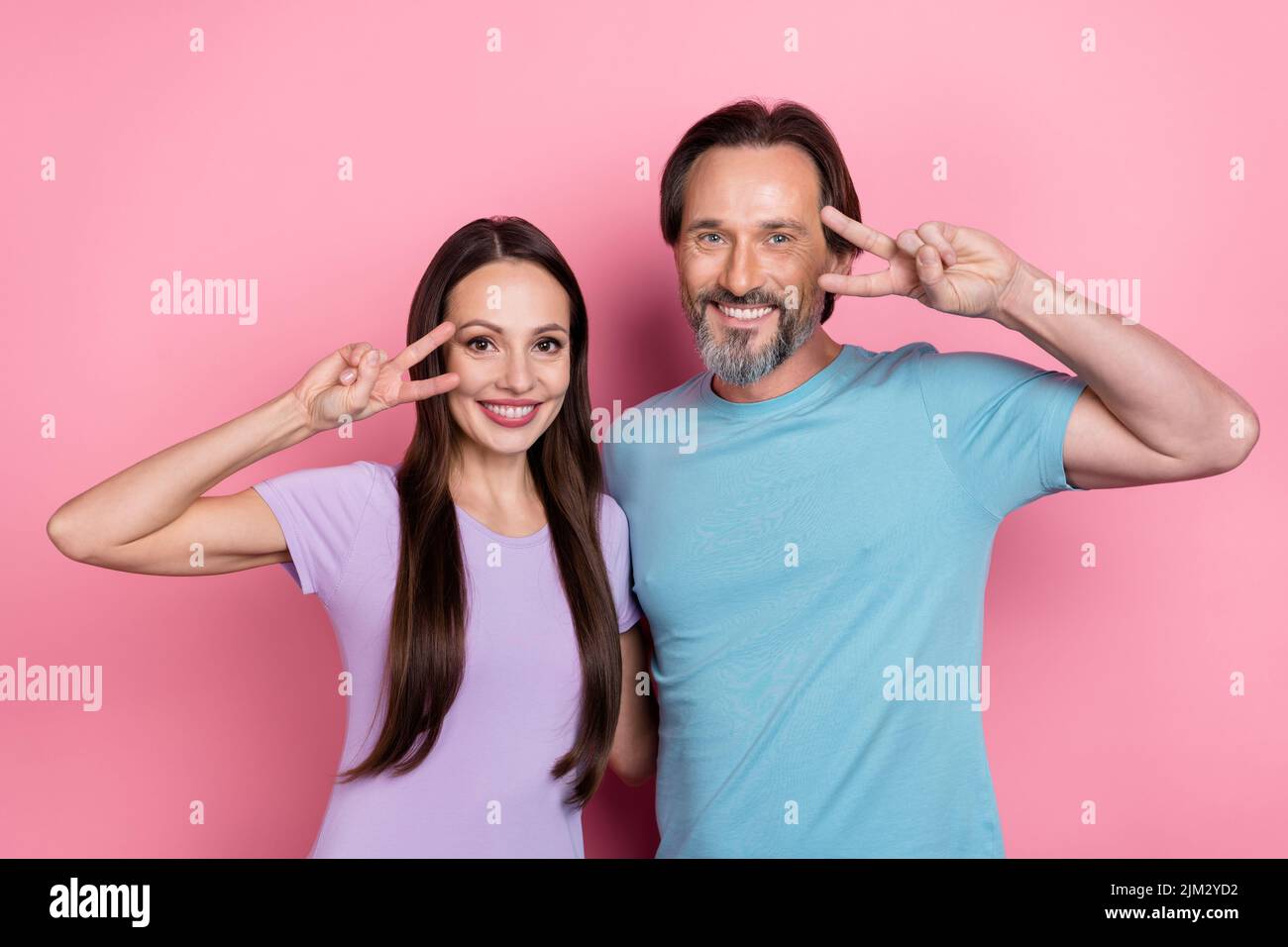 Photo of two satisfied positive partners arm fingers demonstrate v-sign ...