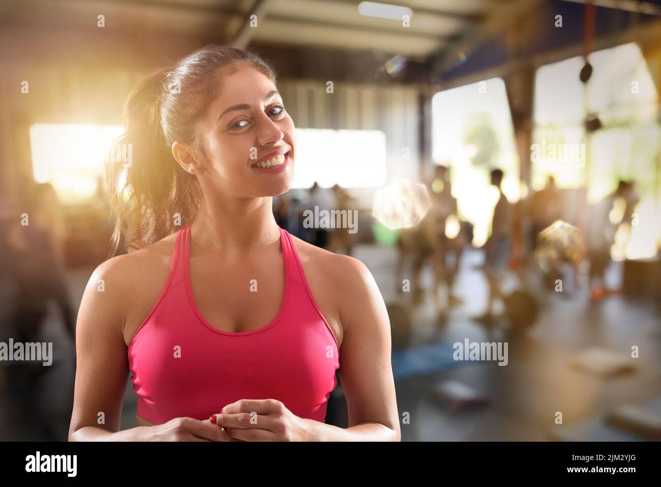 Smiling woman at the gym ready to start fitness lesson Stock Photo - Alamy