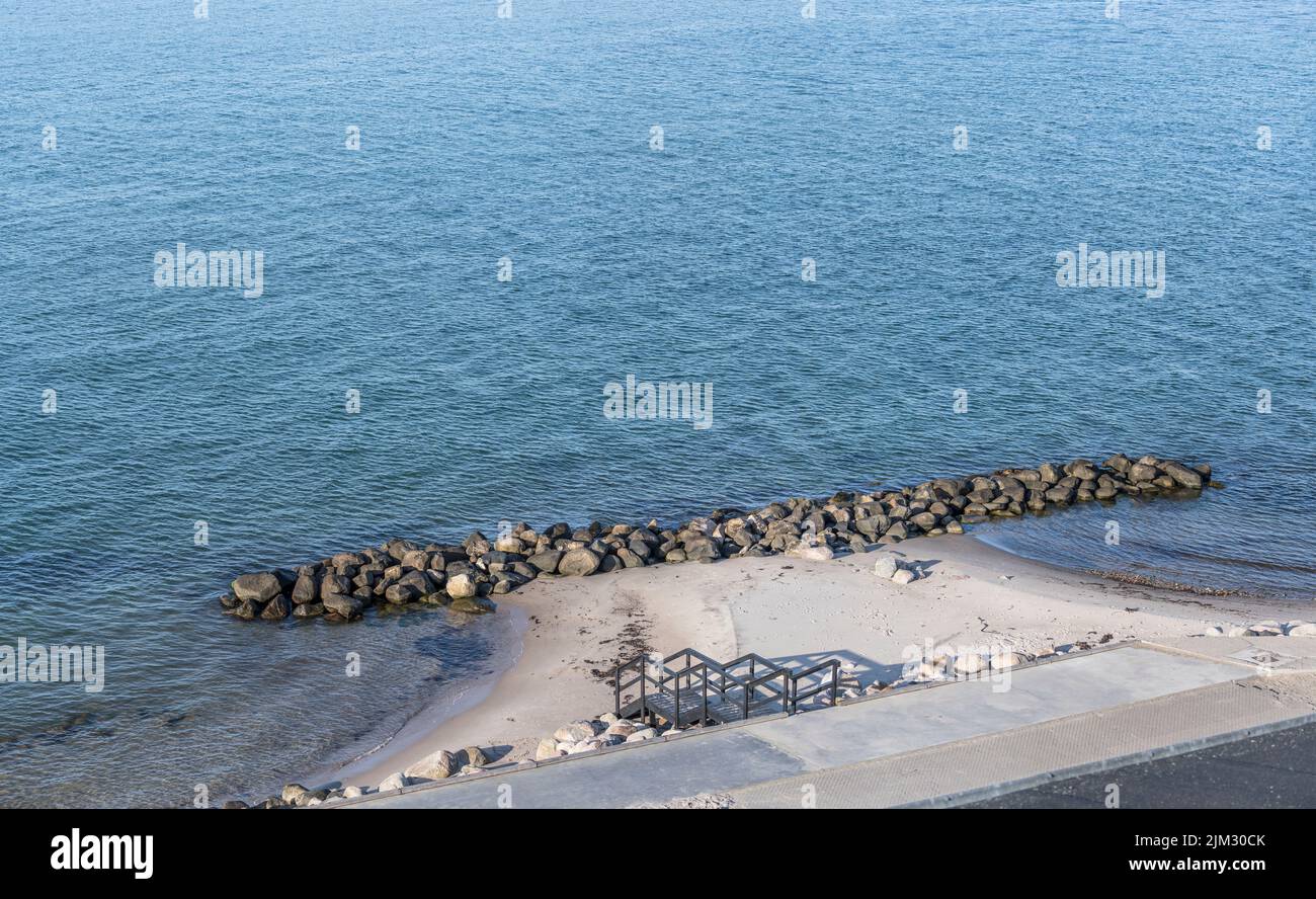 landscape with little sand beach of shore facing waters of Oresund sea ...