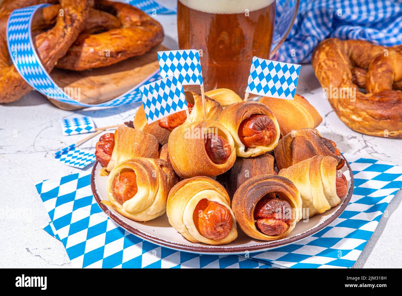 Oktoberfest party food. Pretzel hot dogs, puff pastry rolls with ...