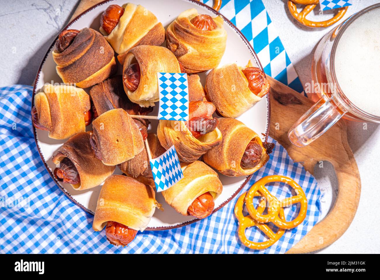 Oktoberfest party food. Pretzel hot dogs, puff pastry rolls with ...