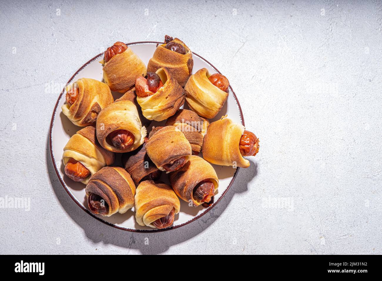 Oktoberfest party food. Pretzel hot dogs, puff pastry rolls with ...