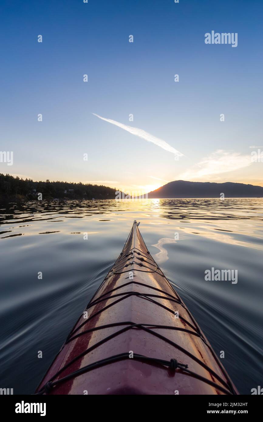 Sea Kayak paddling in the Pacific Ocean. Colorful Sunset Sky Stock ...