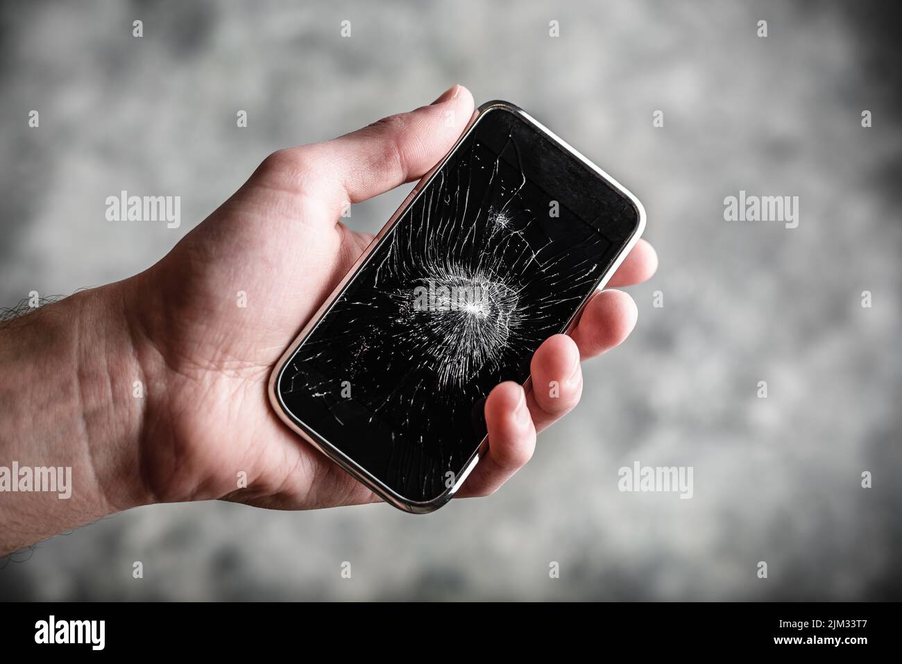 Smart cell phone with a broken screen in hand Stock Photo - Alamy