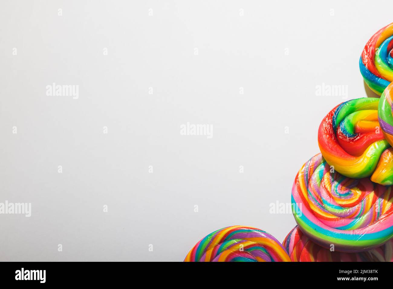 High angle close-up view of multi colored swirl lollipops by copy space ...