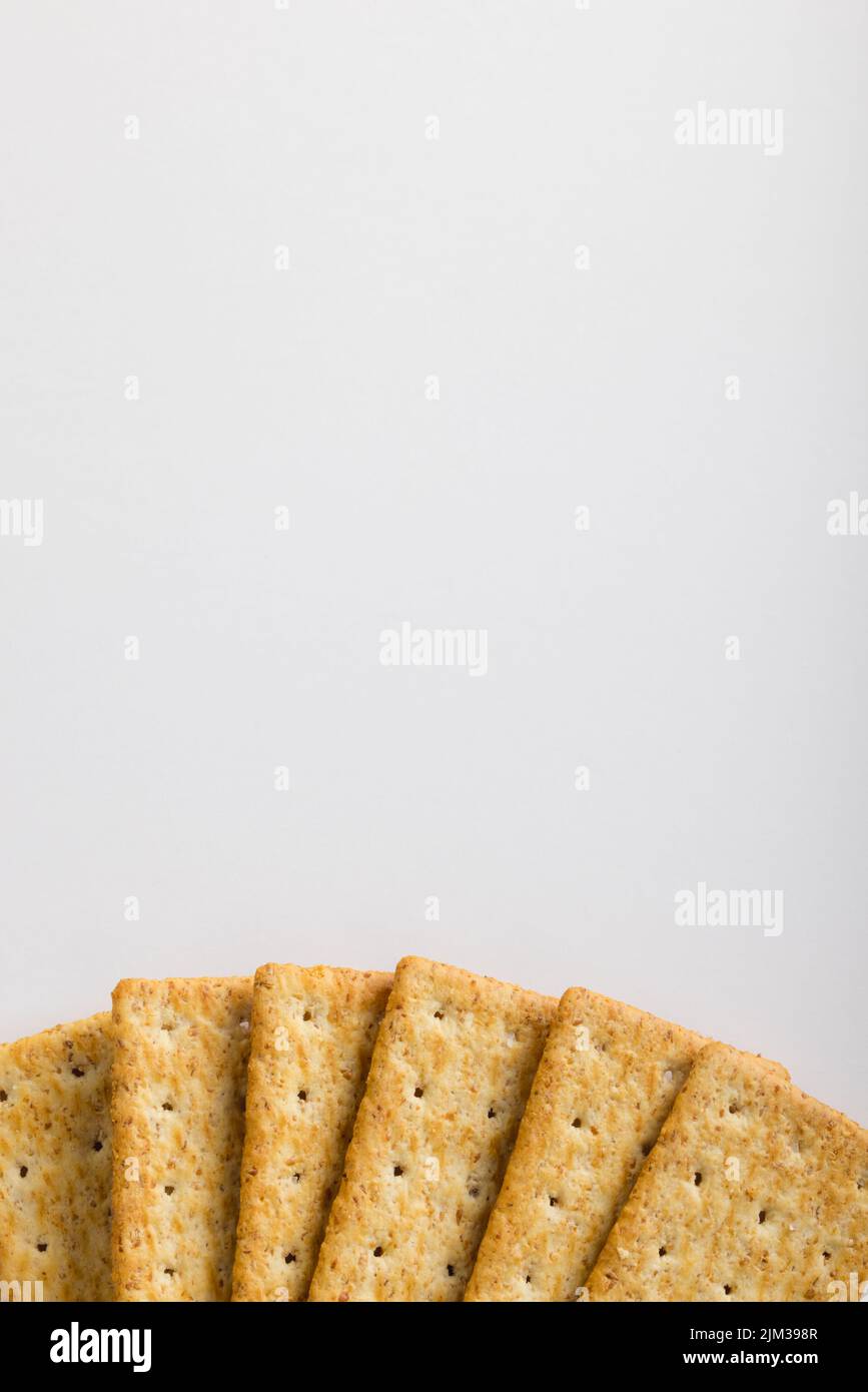Overhead view of crackers arranged on white background with copy space ...