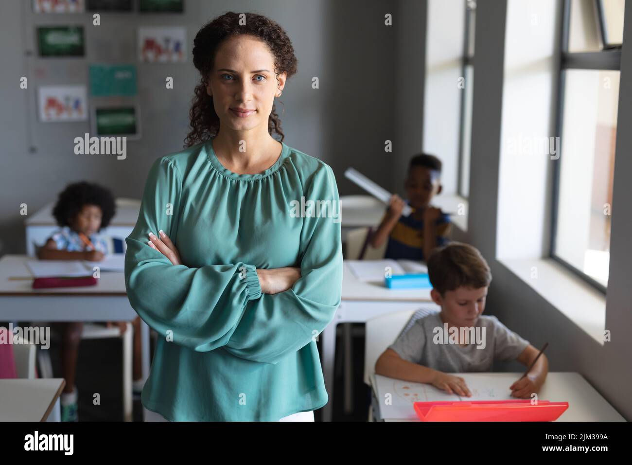 Portrait Of Caucasian Young Female Teacher With Arms Crossed Standing