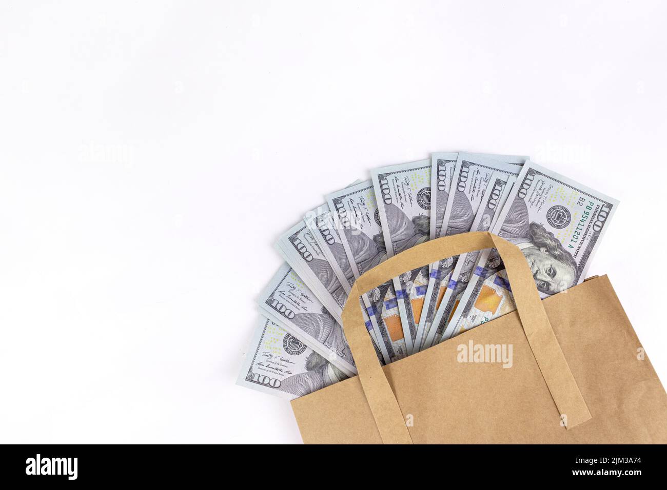 Close-Up Of Paper Currency In package bag delivery Against White ...