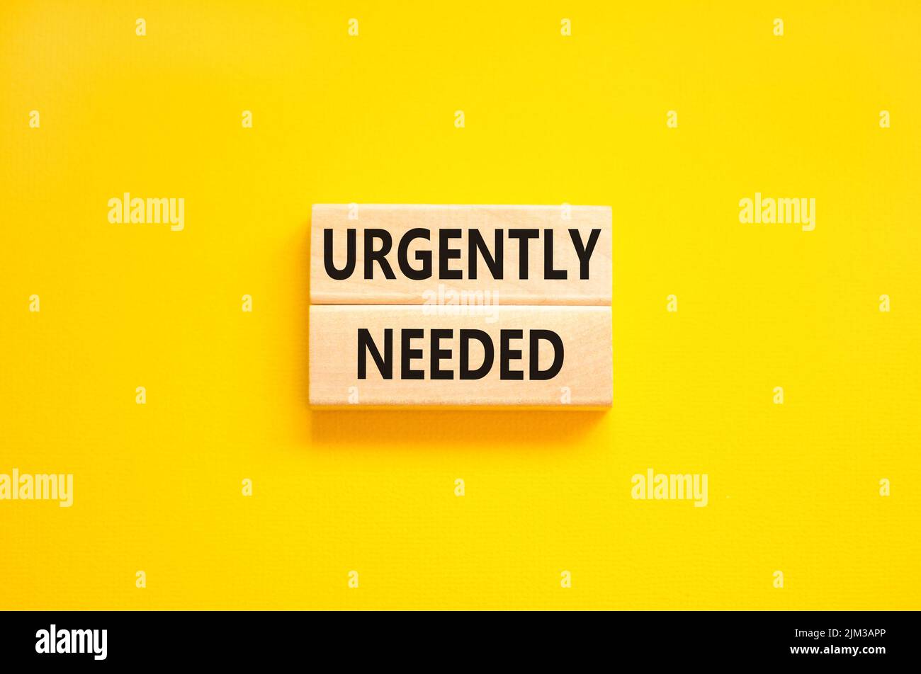 Urgently needed symbol. Concept words Urgently needed on wooden blocks ...