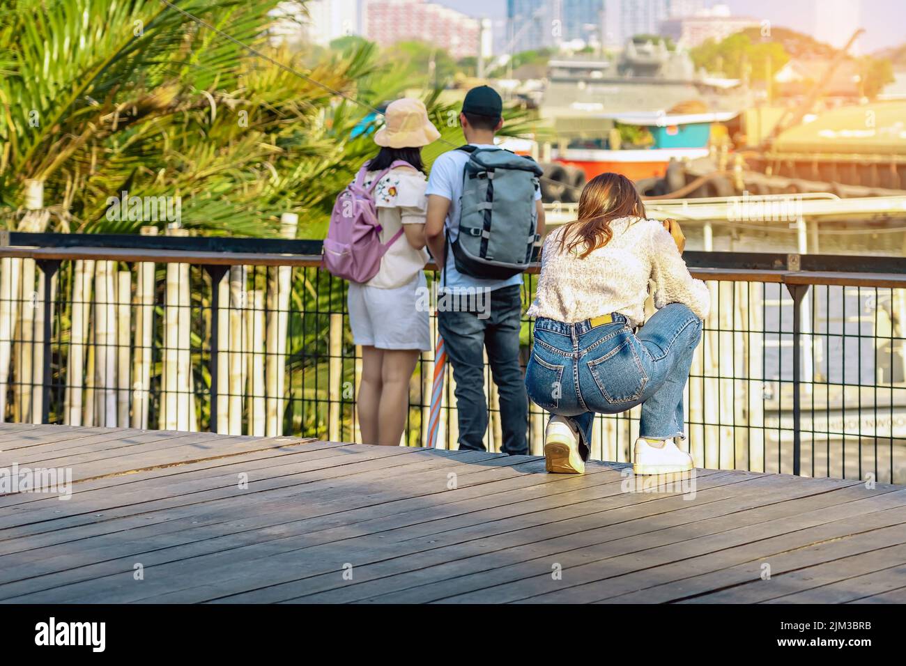 Back view portrait of attractive Asian woman photographer or traveller ...