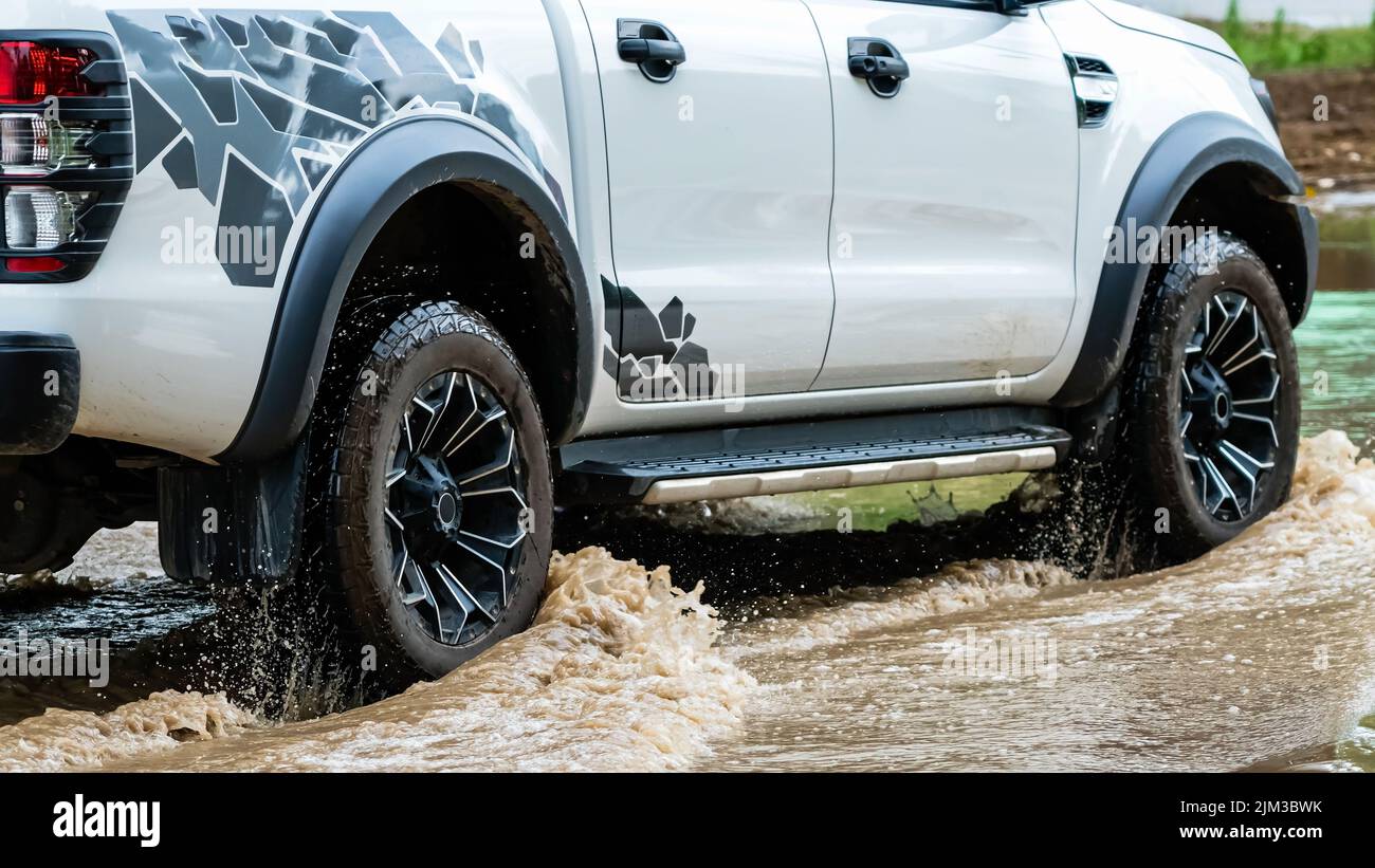 Pickup truck passing through flooded road. Driving car on flooded road ...