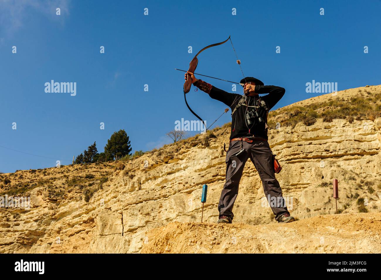 Young man aiming bow arrow hi-res stock photography and images - Alamy