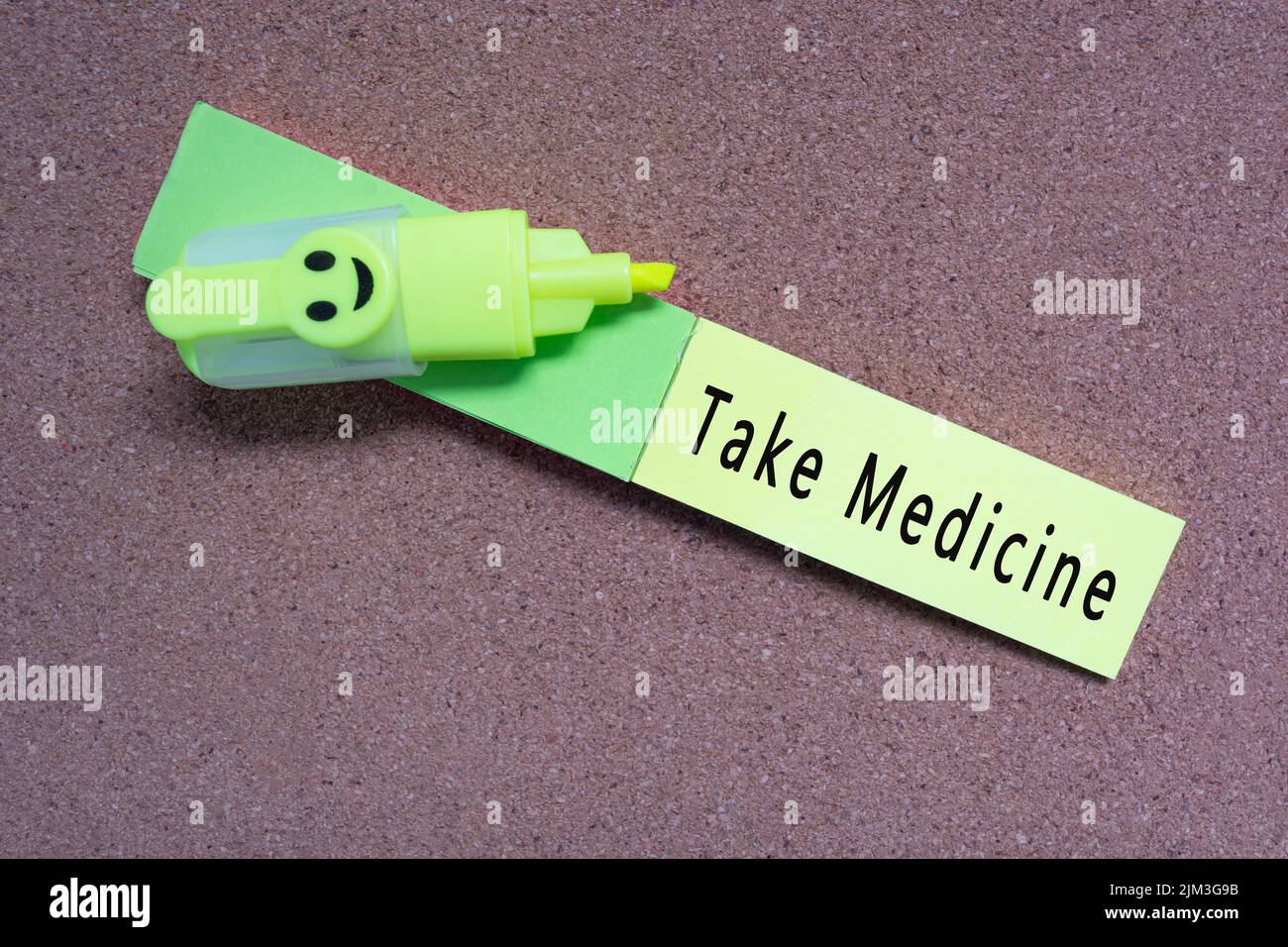 Take medicine words on yellow note on wooden board. Medical concept ...