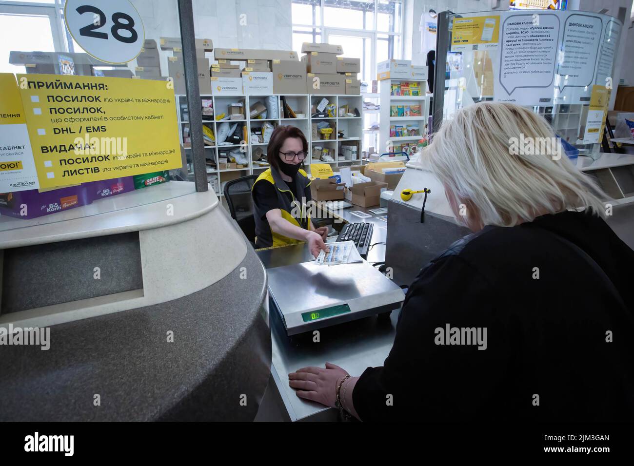 A woman buys a new series of postage stamps commemorating the ...