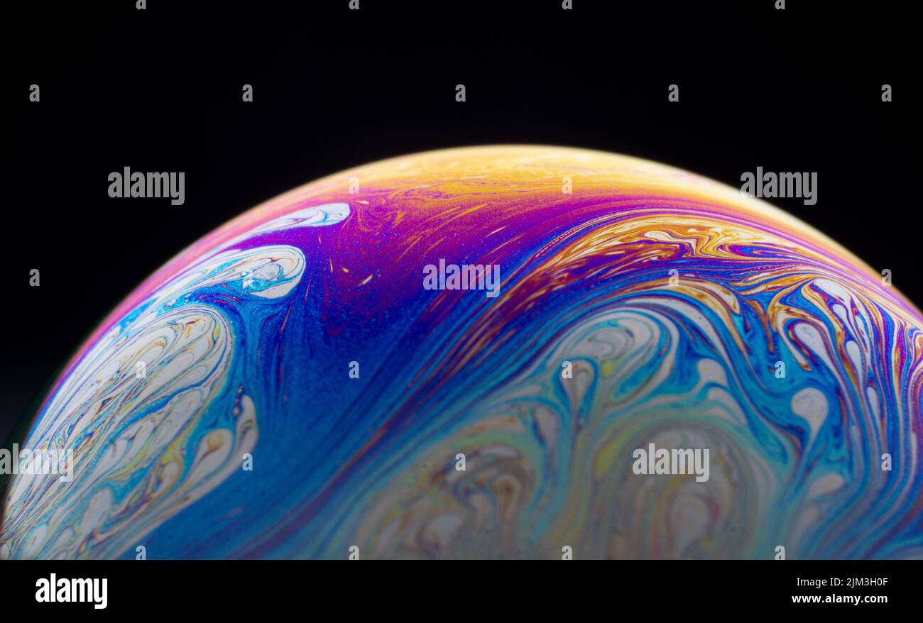Half a soap bubble. Close-up. Black background. Bright colors. Side ...