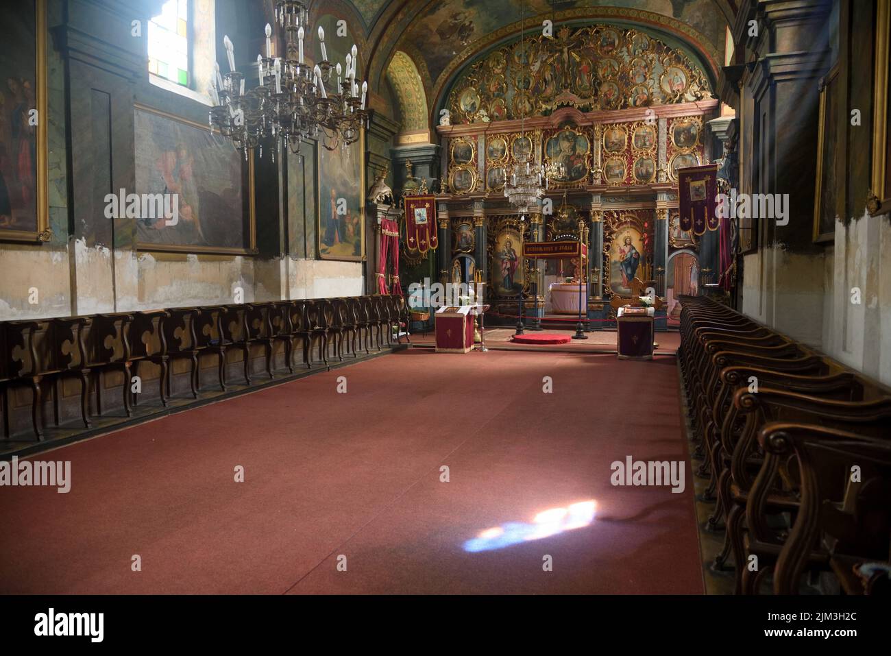 An interior of an empty church rich in religious paintings and ...