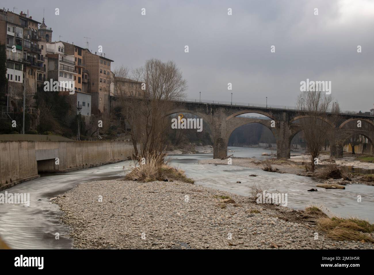 An old stone bridge under a foggy sky in Roda de Ter, Spain Stock Photo ...
