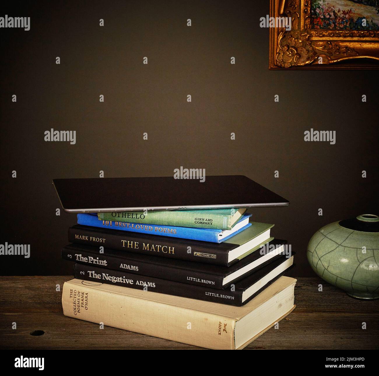 A modern day library with a stack of books and an ipad Stock Photo - Alamy