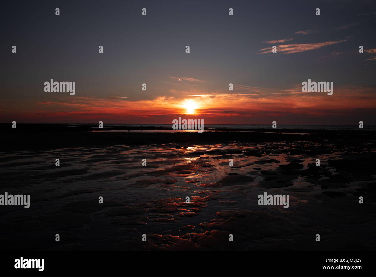 A beautiful shot of a sunset sky over the Caota dune beach in Taiwan ...