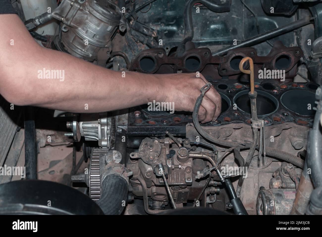 The mechanic is checking the engine. The mechanic is checking the ...