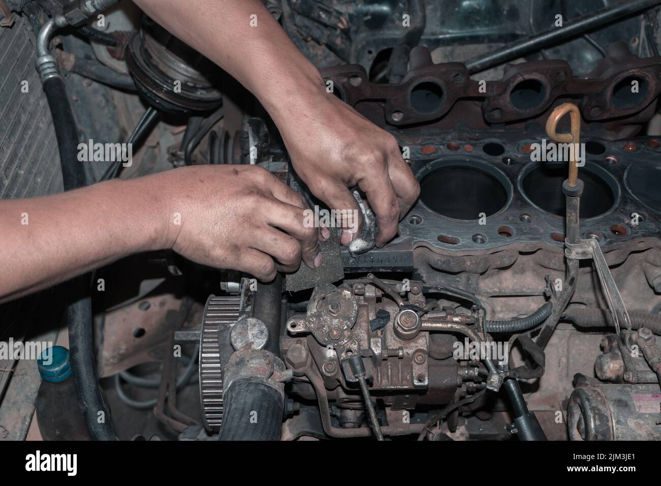 The mechanic is checking the engine. The mechanic is checking the ...