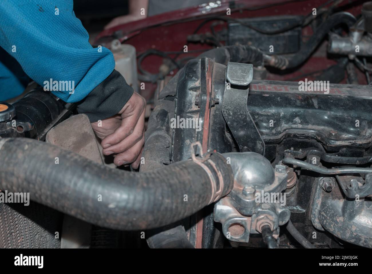 The mechanic is checking the engine. The mechanic is checking the ...