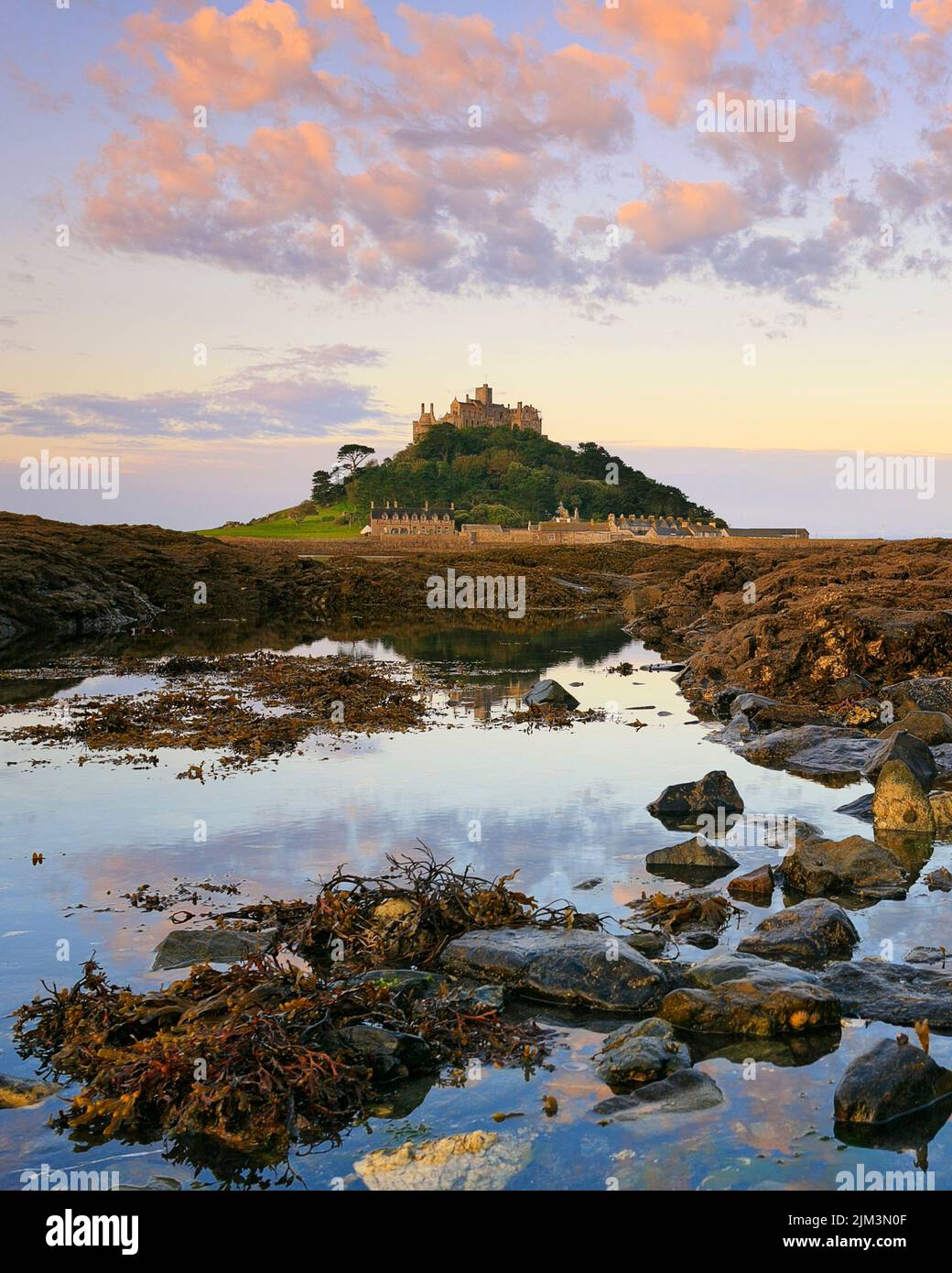 A vertical of a castle on top of St. Michaels Mount surrounded by ...