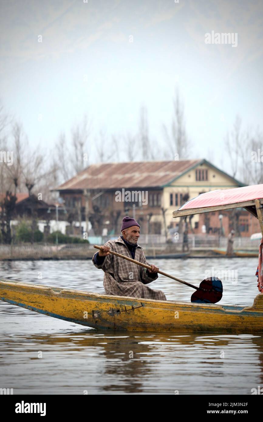 A portrait of a Kashmiri Shikara boat sailor Indian man on Dal Lake ...