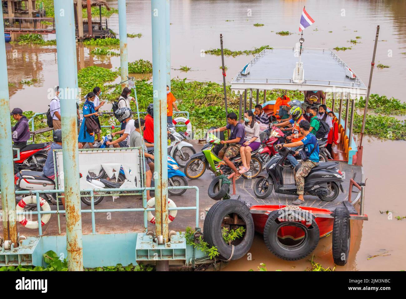 A Thai ferry boat with passengers crosses the Chaophraya River in ...
