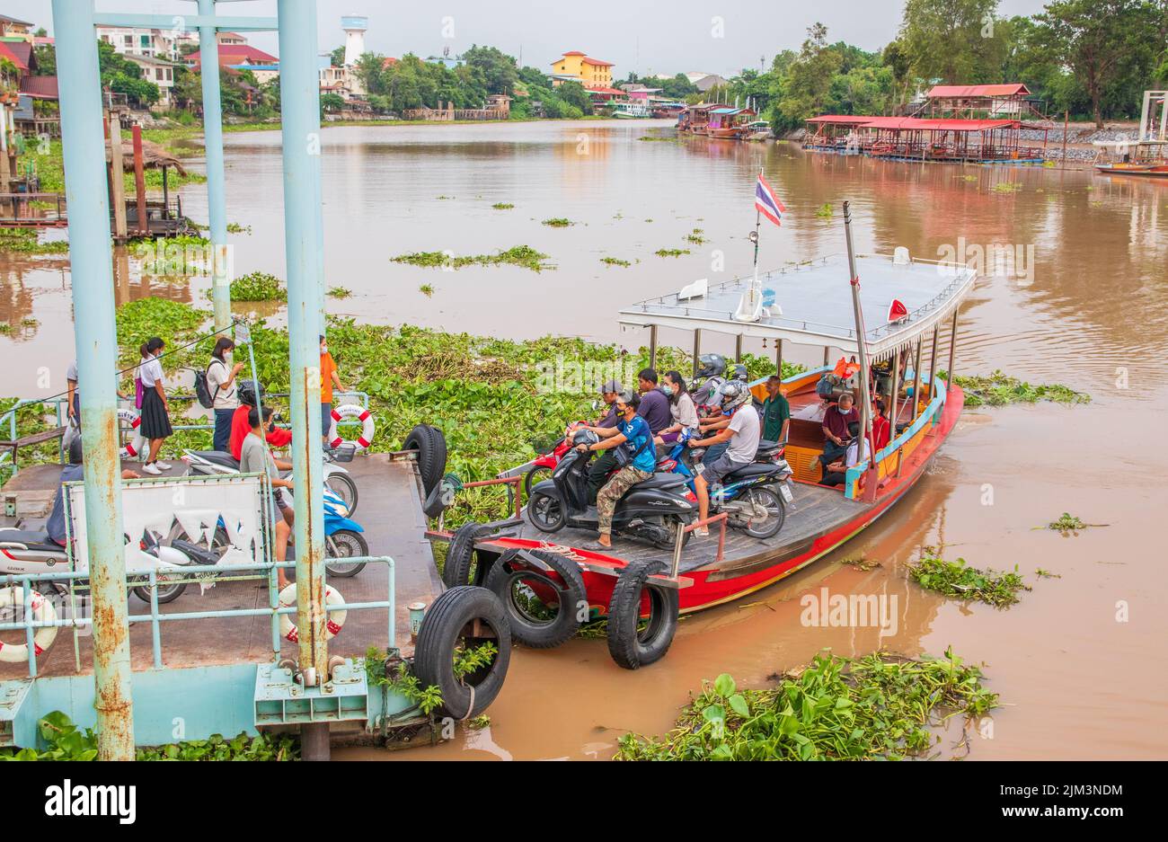 A Thai ferry boat with passengers crosses the Chaophraya River in ...