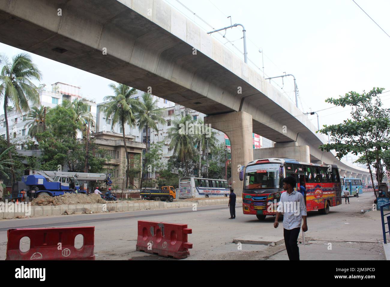 The buses and people on the street under the bridge in Mirpur, Dhaka ...
