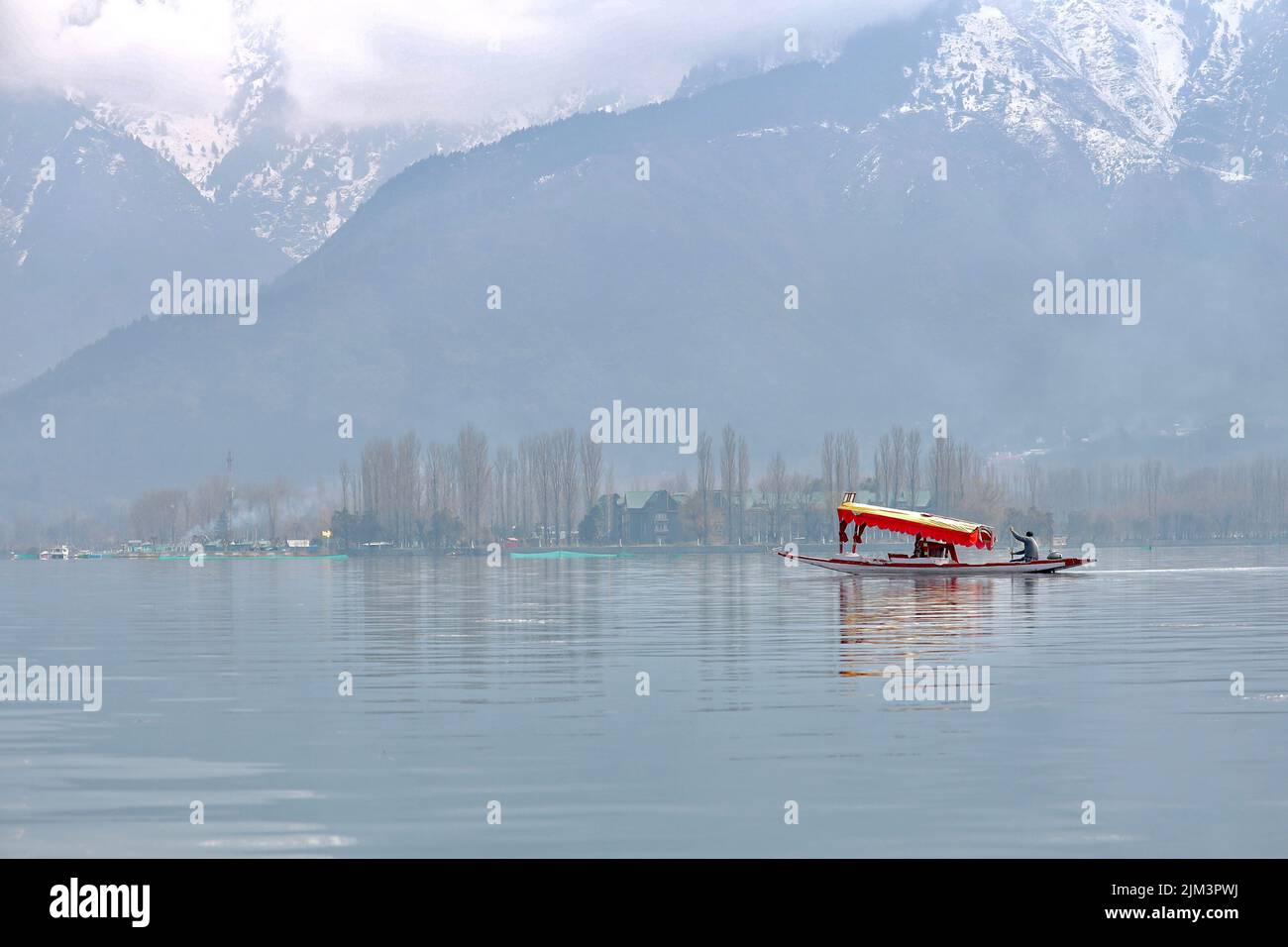 A silhouette of a Kashmiri Shikara boat sailor Indian man on Dal Lake ...