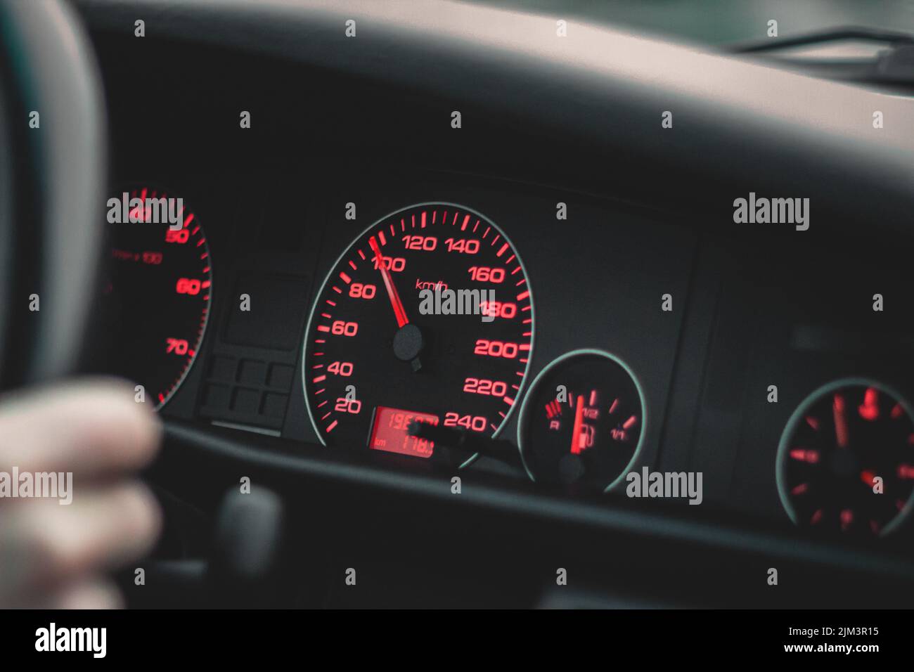 A closeup of a car speedometer dashboard showing 100 kilometers per ...