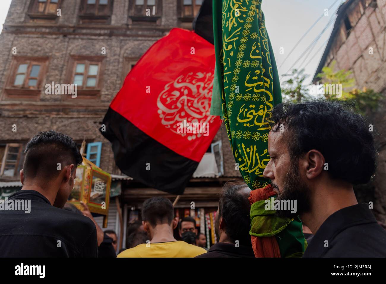 Shia Muslims participate in a religious procession on the 5th day of ...