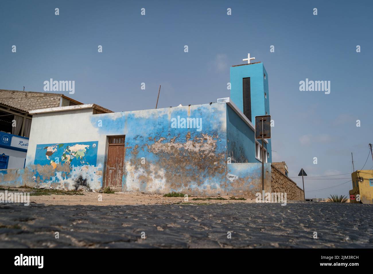 a low angle shot of an old blue church building Stock Photo - Alamy