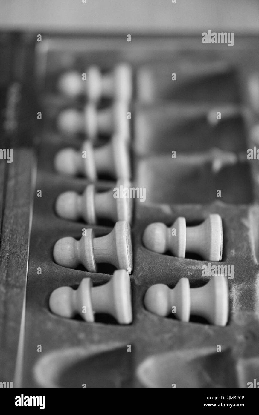 A grayscale shot of the chess pieces in box chessboard, business ...