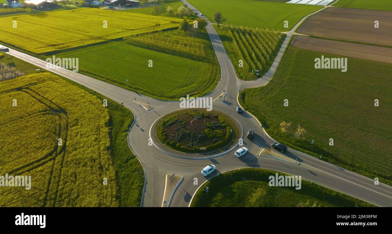 The roundabout with cars surrounded by greenery in Germany Stock Photo ...