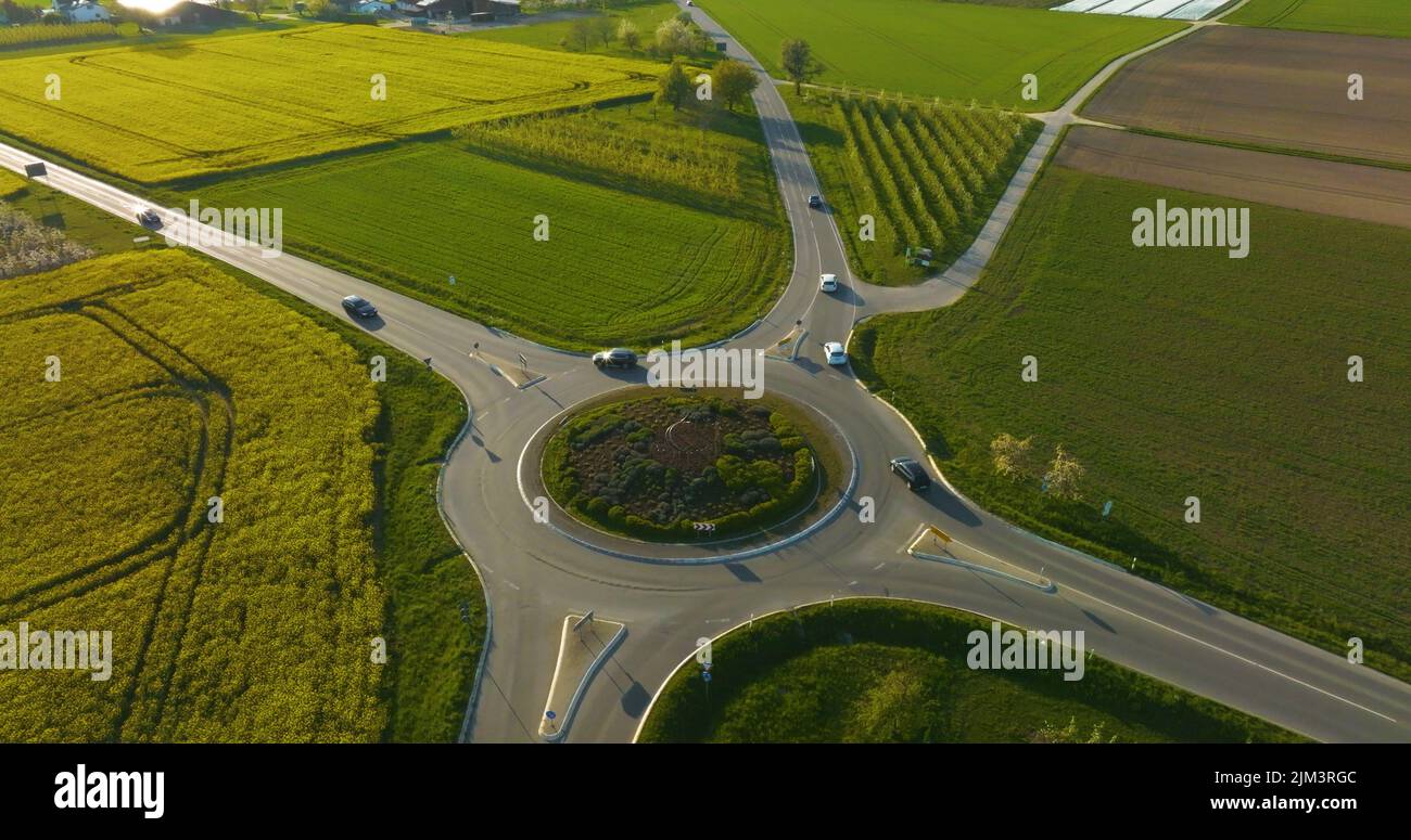 The roundabout with cars surrounded by greenery in Germany Stock Photo ...