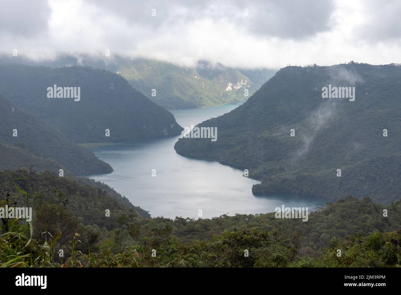 Remote Laguna Brava with clouds above seen from above in guatemala ...