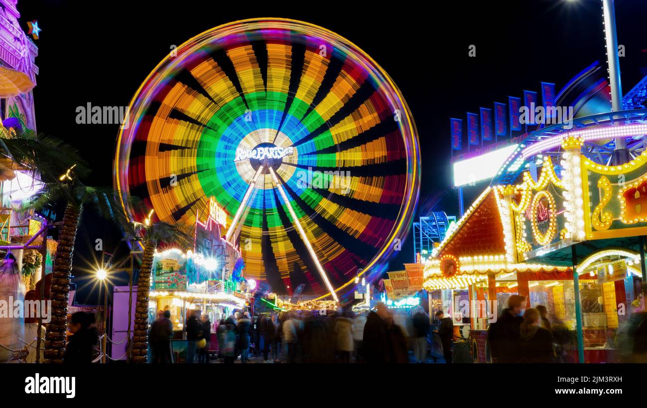 Spinning ferris wheel in motion on funfair. An abstract blurred ...