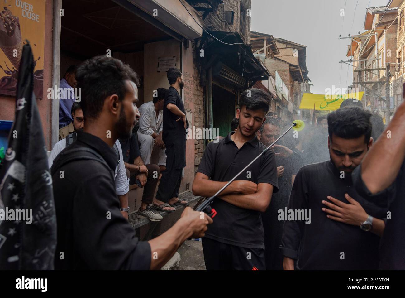 Srinagar, India. 04th Aug, 2022. A Shia man sprays rose water on ...