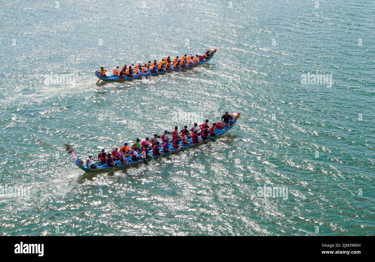 The two dragon boats on the river and racing Stock Photo - Alamy